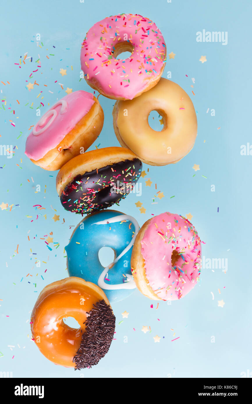 flying doughnuts on blue Stock Photo - Alamy