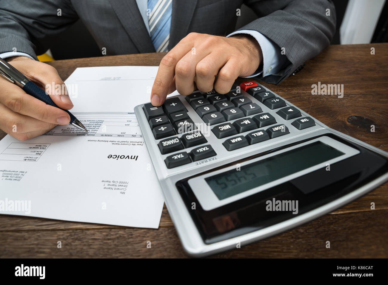 Close-up Of Businessperson Calculating Financial Sheet With Calculator ...