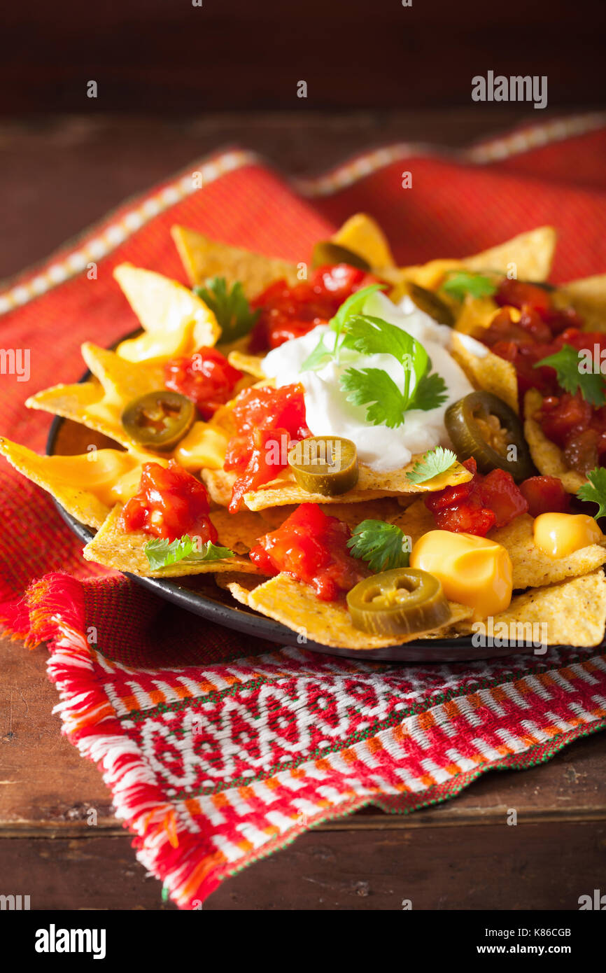 nachos loaded with salsa, cheese and jalapeno Stock Photo - Alamy