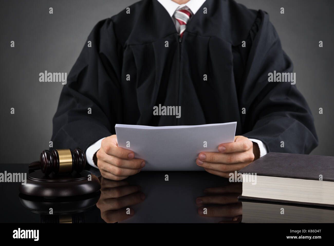 Close-up Of Male Judge Reading Paper In Courthouse Stock Photo - Alamy