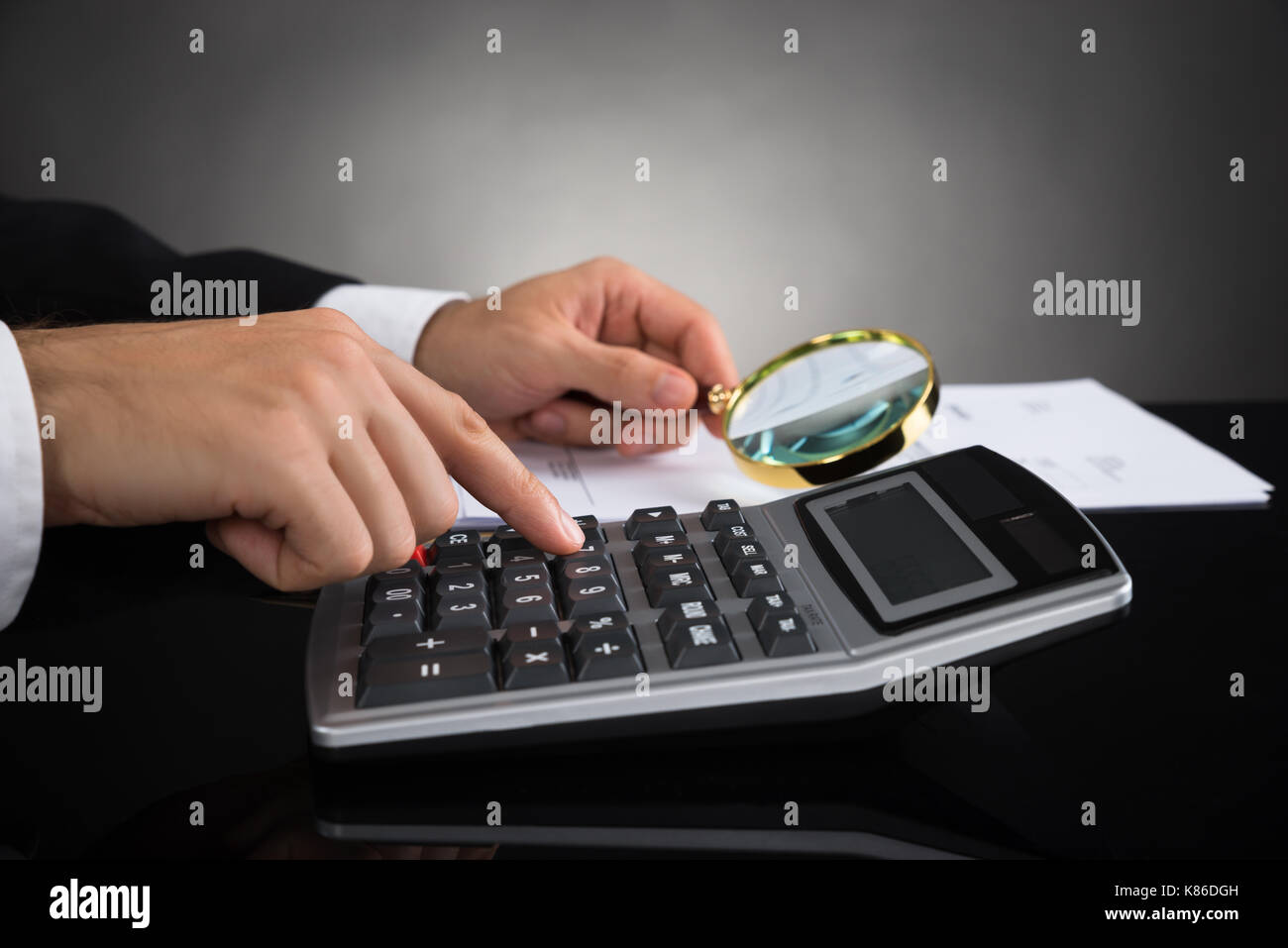 Close-up Of Businessperson Inspecting Invoice With Magnifying Glass And ...