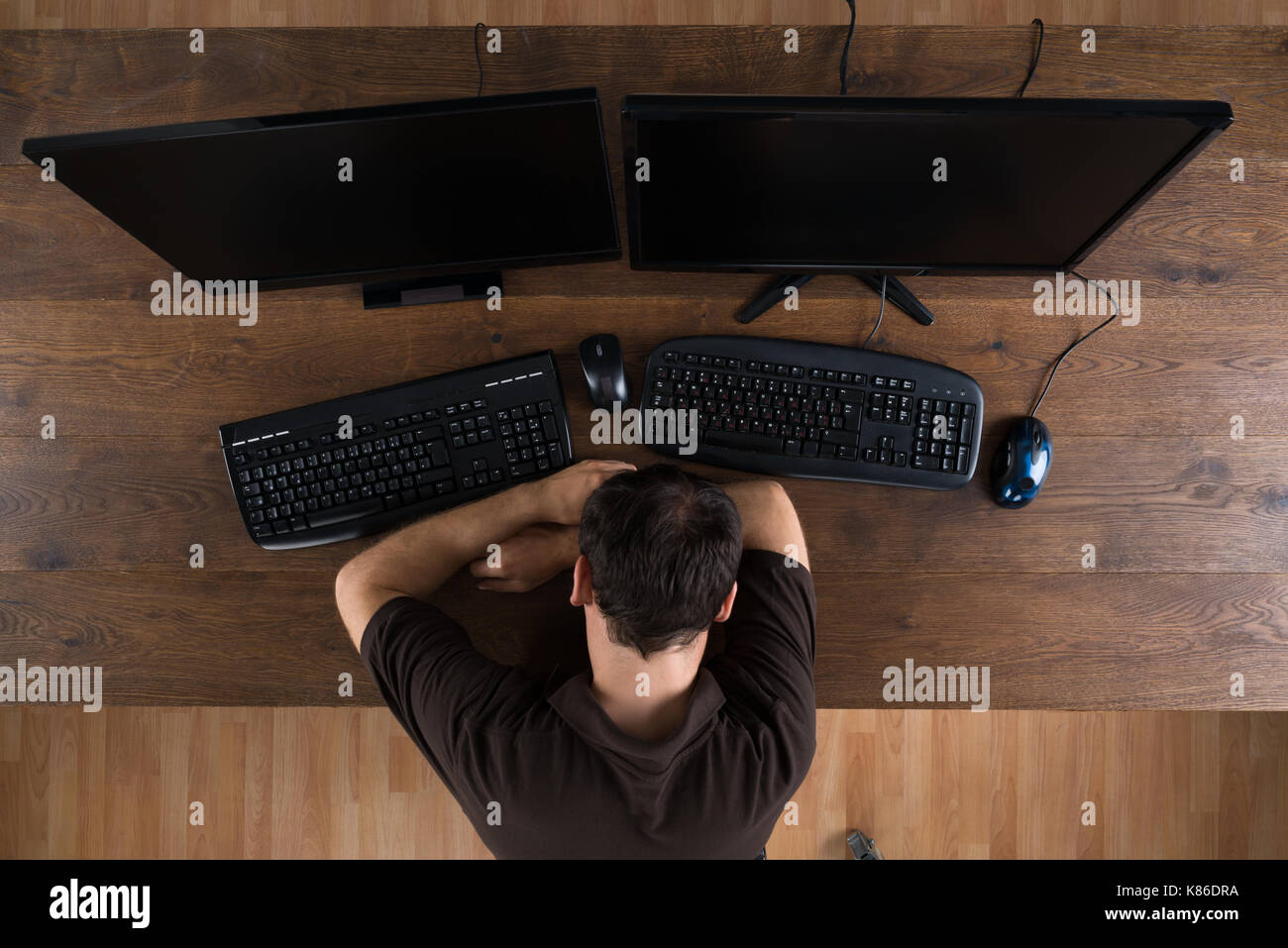 Man Sleeping At Desk With Computers Showing Program Code Stock Photo ...