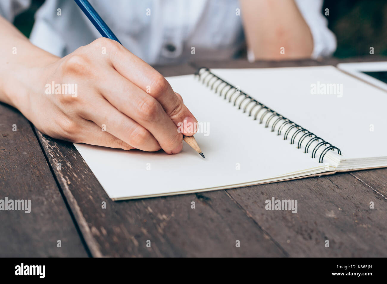 Hipster woman hand writing notebook paper in coffee shop Stock Photo ...