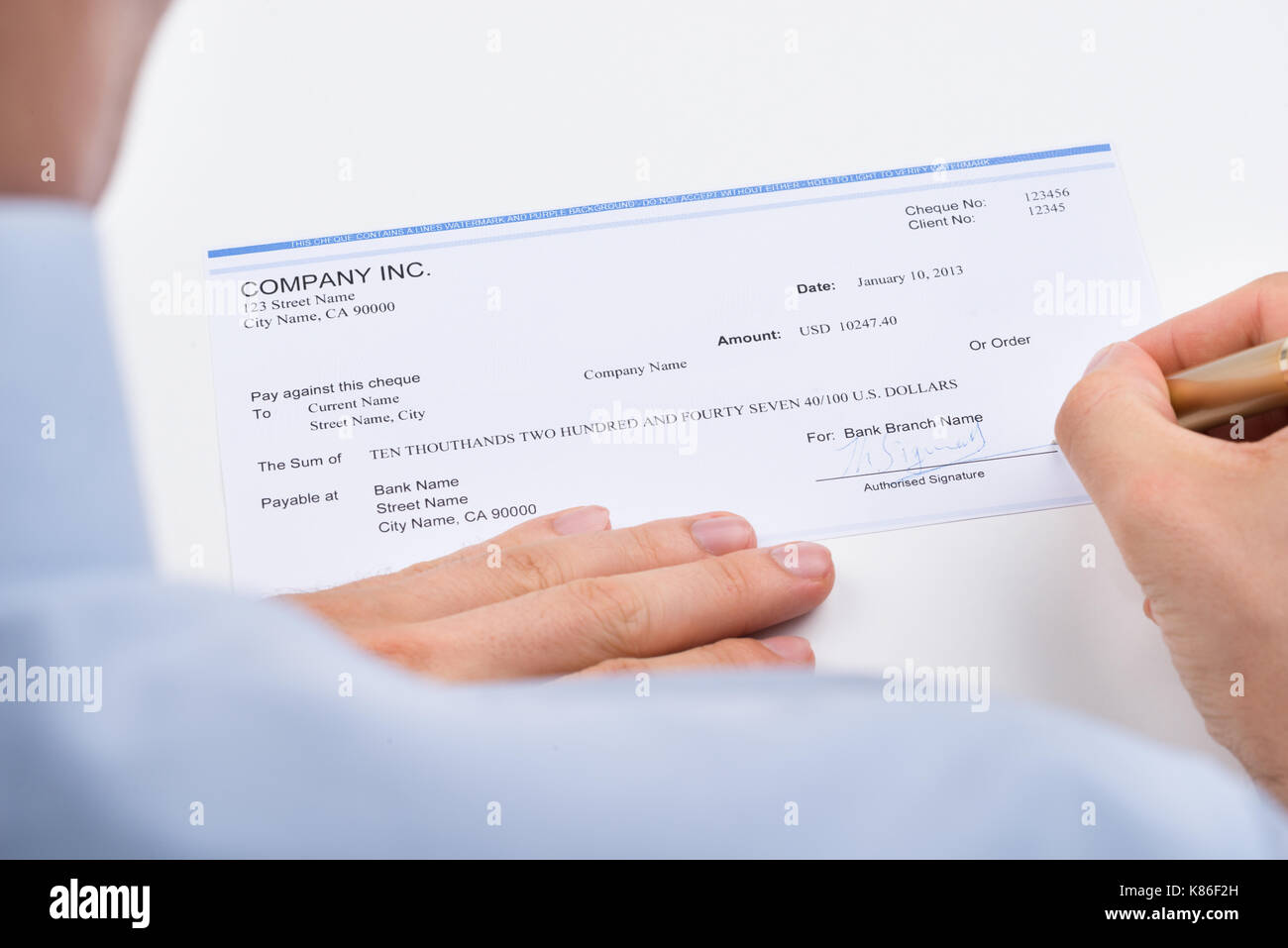 Close-up Of Businessperson Hands With Pen Signing Cheque Stock Photo ...