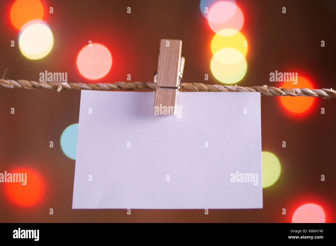 paper holding on rope for present and write your words with bokeh ...