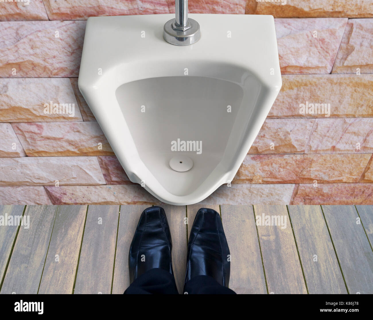 man standing infront of urinals to get pee or piss in toilet Stock ...