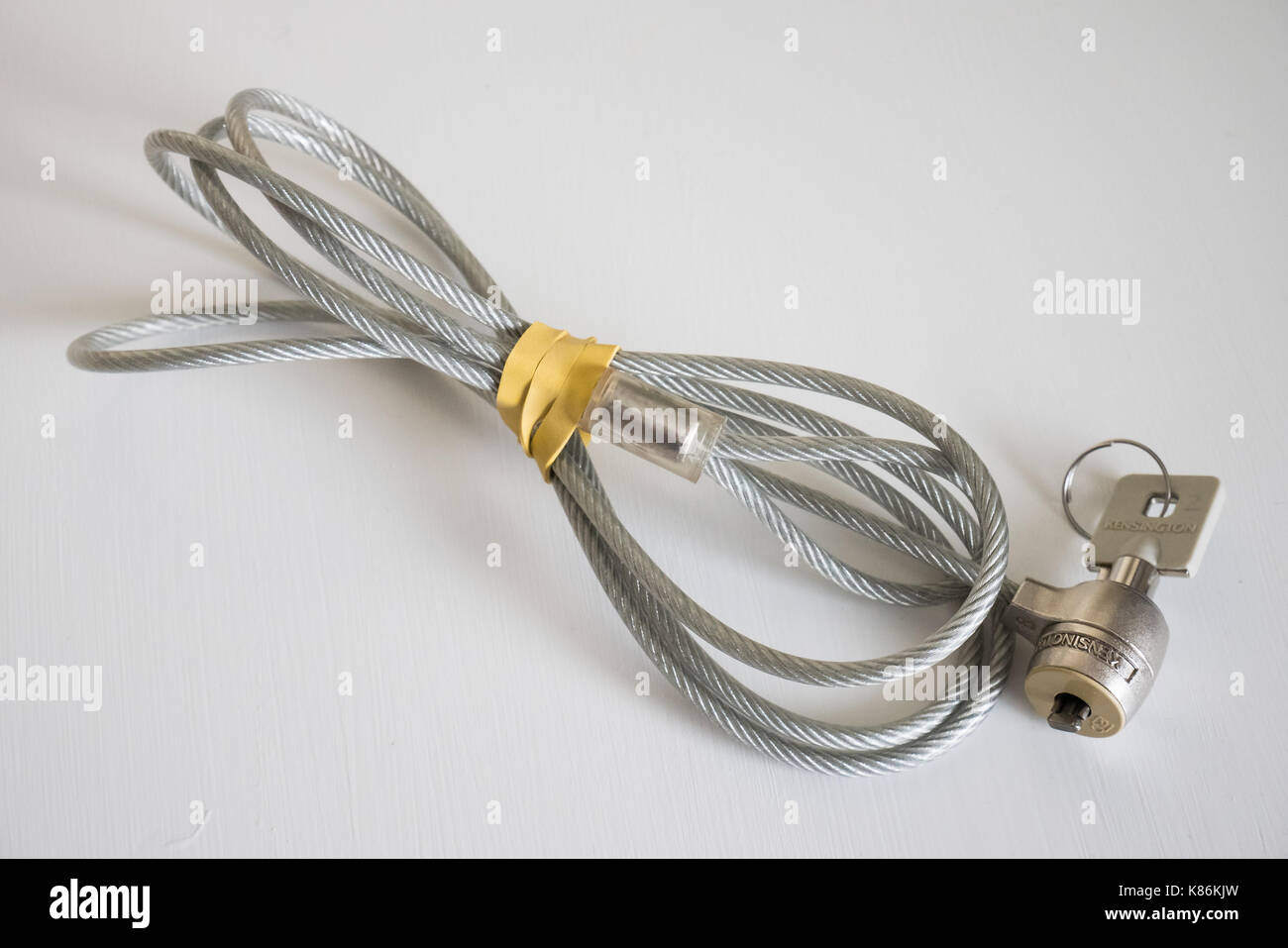 Kensington steel wire laptop lock with key Stock Photo - Alamy