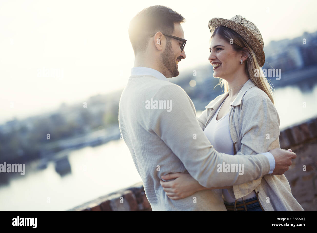 Happy romantic couple hugging and smiling Stock Photo - Alamy