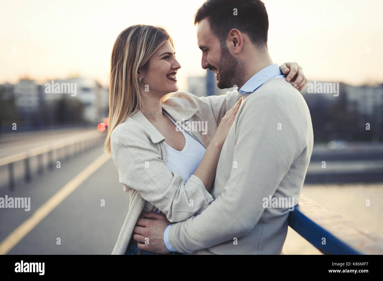 Happy romantic couple hugging and smiling Stock Photo - Alamy