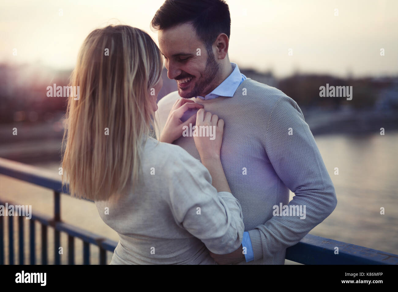Happy romantic couple hugging and smiling Stock Photo - Alamy