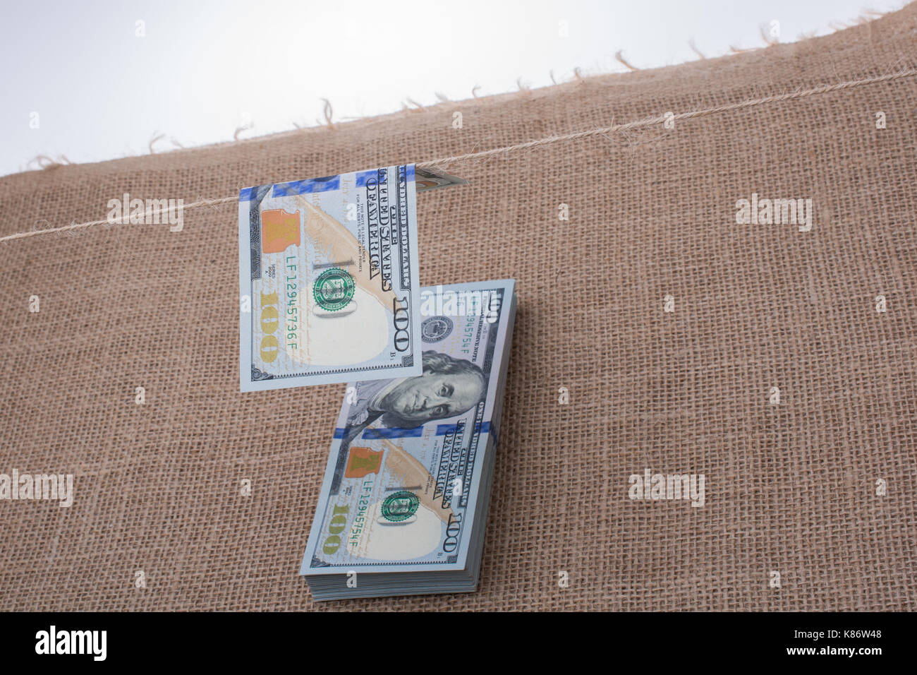 Banknote of US dollar hanging on a linen string Stock Photo - Alamy