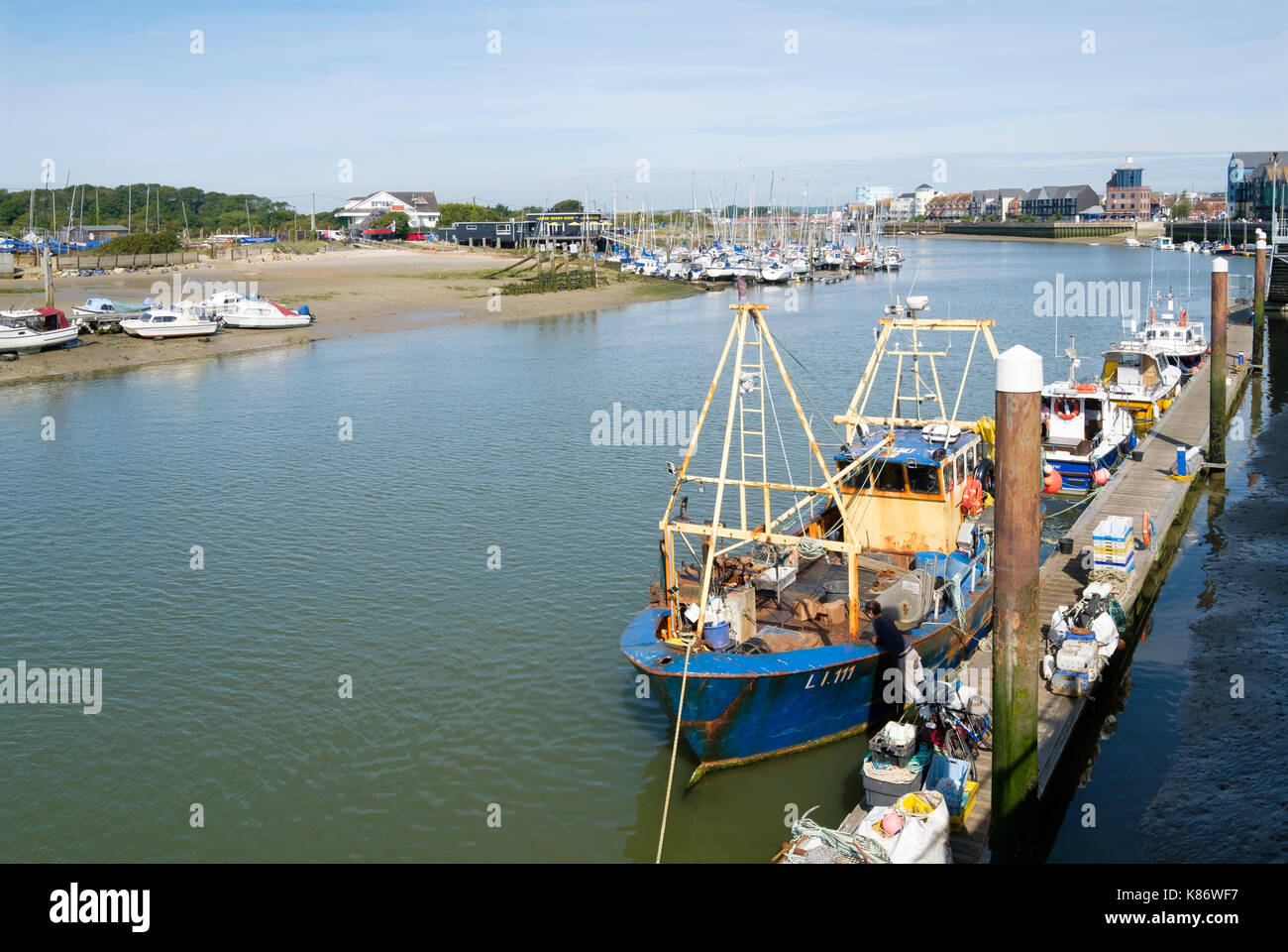 Moored fishing boat and motor cruisers on the river Arun, Littlehampton ...