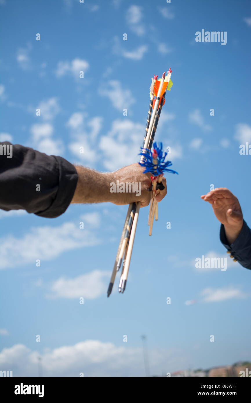 Hand holding old style wooden arrows Stock Photo - Alamy