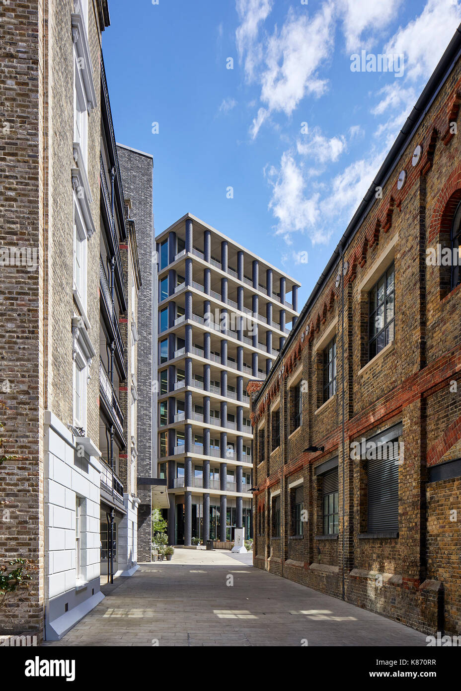 View through buildings towards the Iron columns of One Pancras Square ...