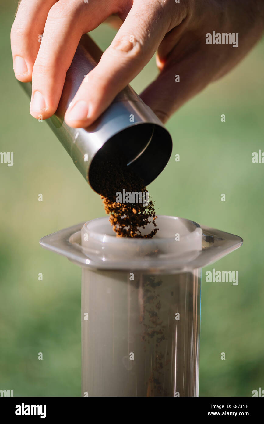 Delicious freshly ground morning coffee beans being thrown into manual ...