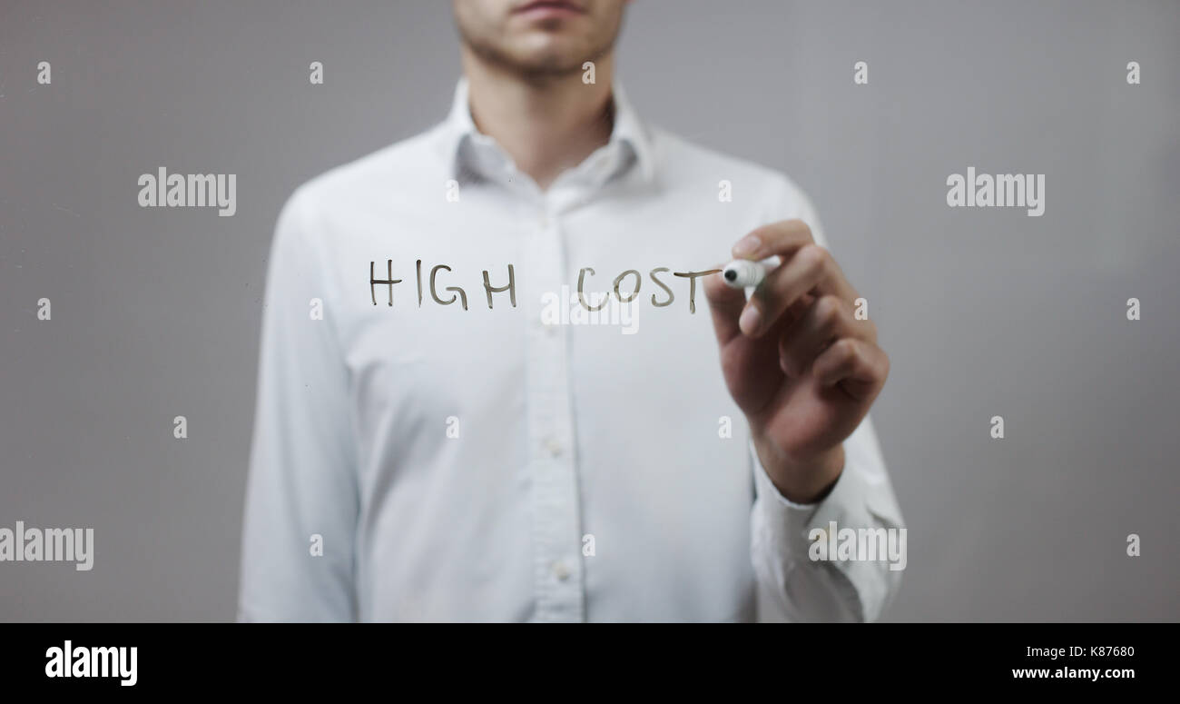 High cost man writing hi-res stock photography and images - Alamy
