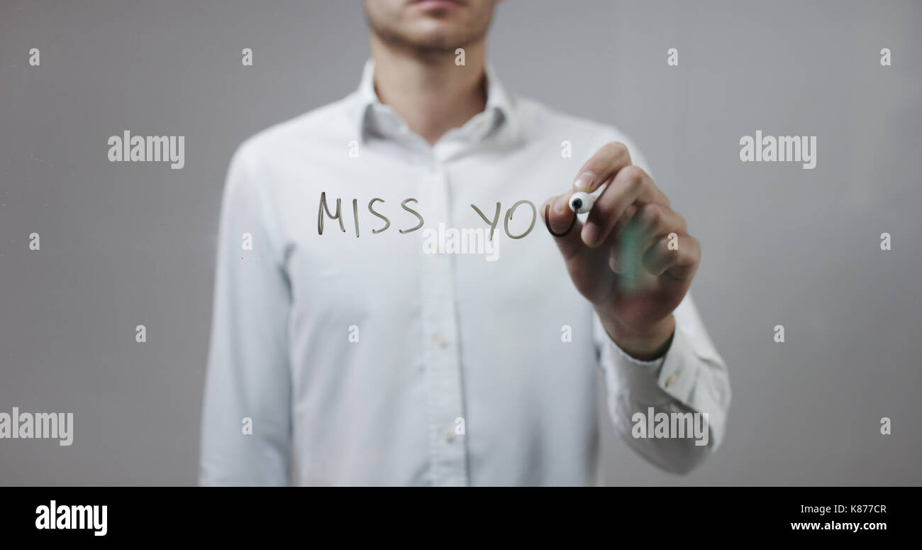 Miss you , Man Writing on Glass Stock Photo - Alamy