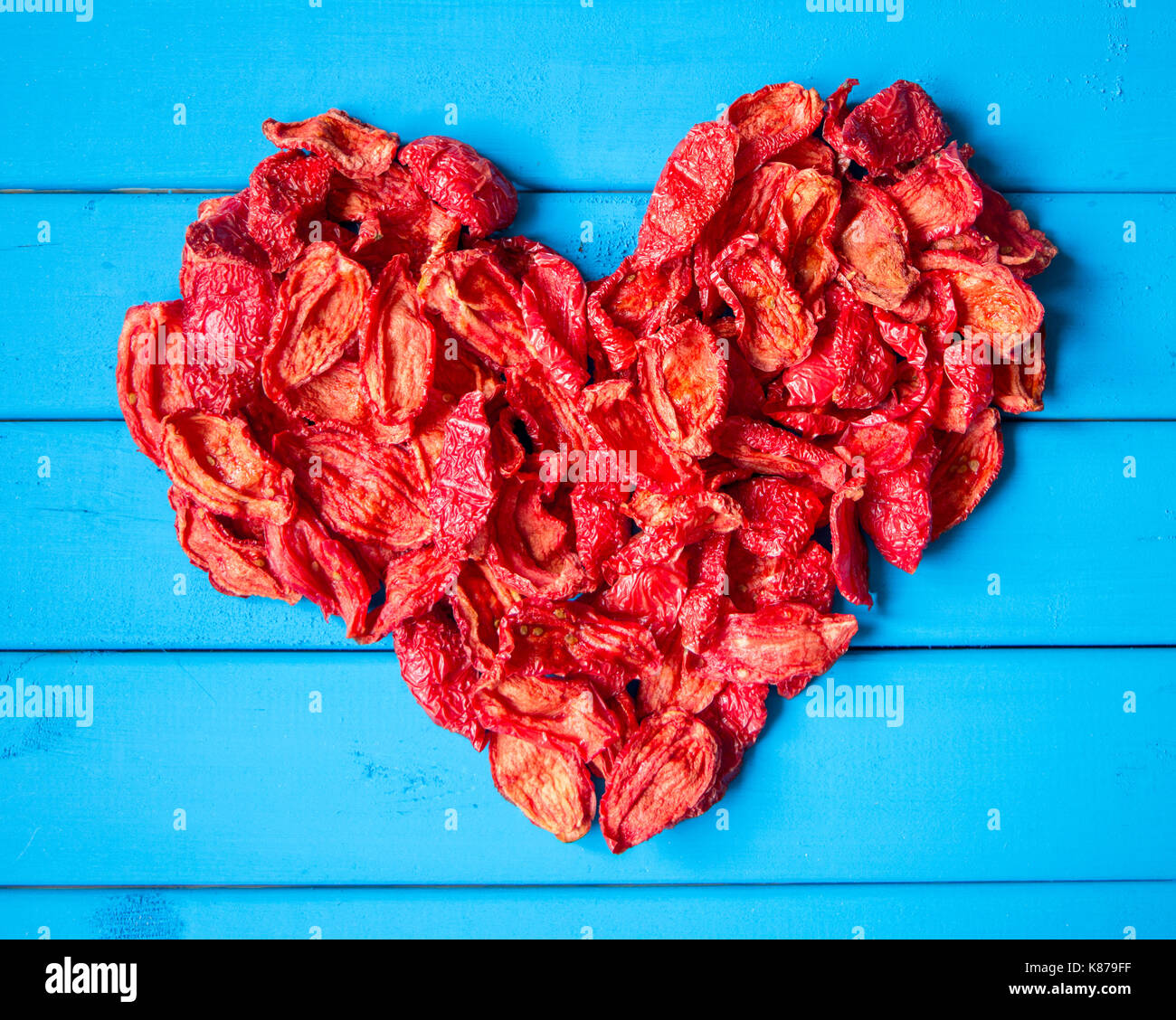 background with heartshape of sun dried tomato slices Stock Photo - Alamy