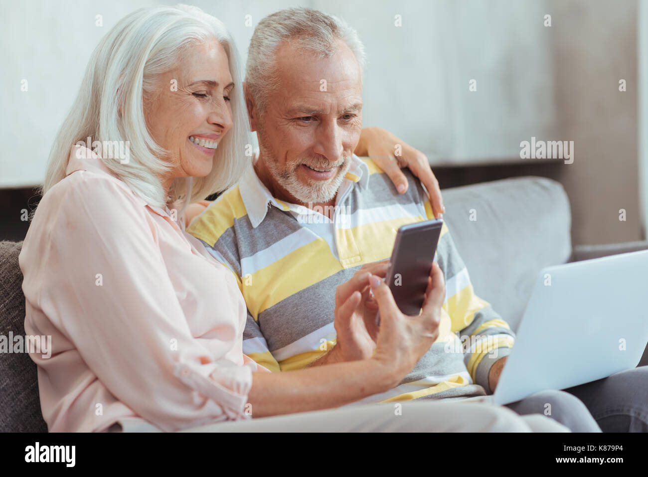 Positive couple using devices hi-res stock photography and images - Alamy
