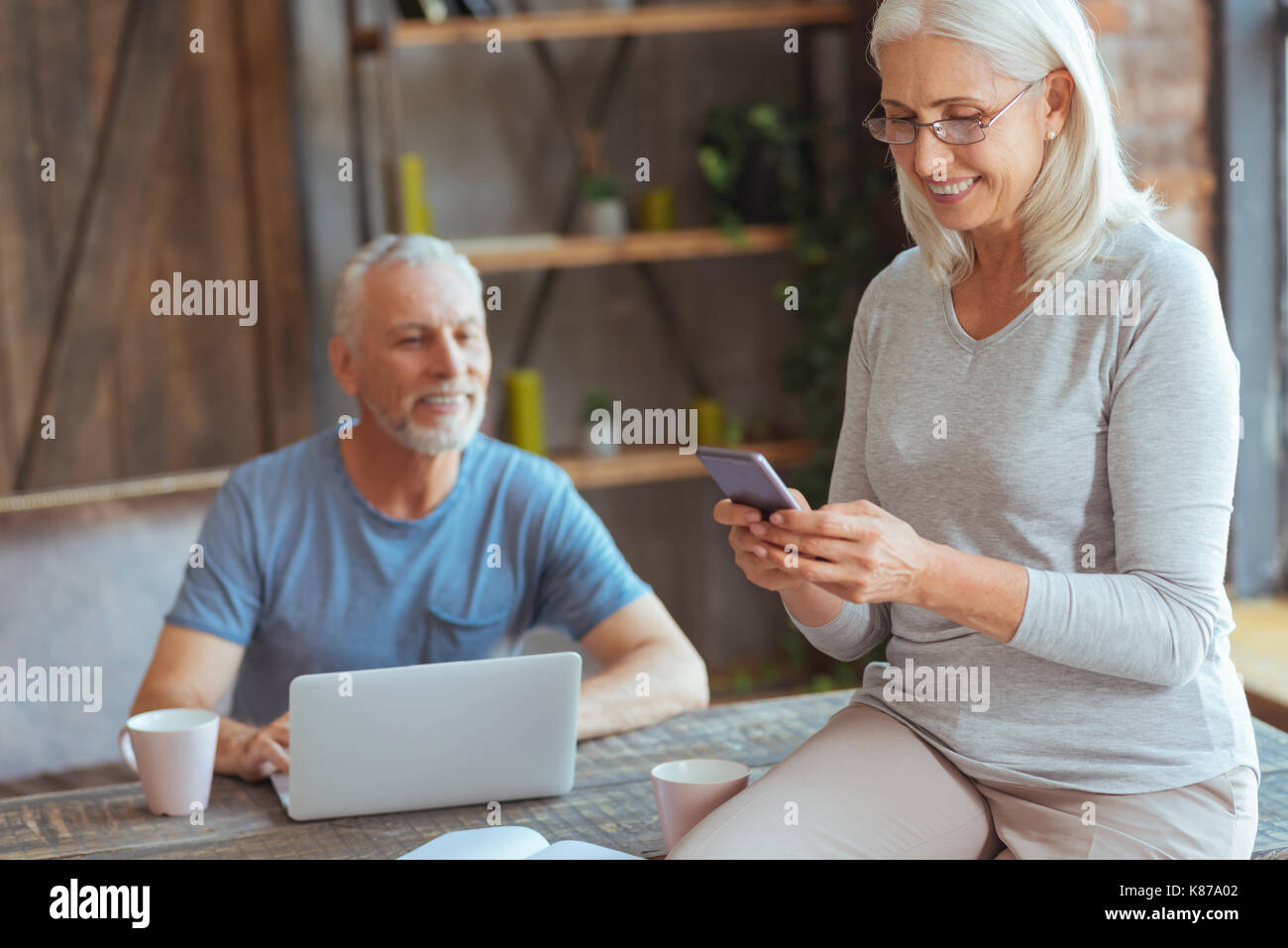 Joyful elderly woman using her smart phone Stock Photo - Alamy