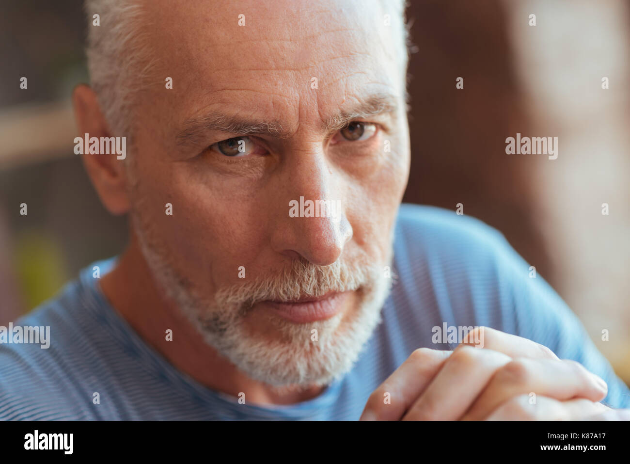 Close up of a serious aged man looking at you Stock Photo - Alamy