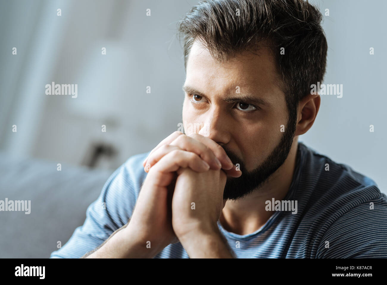Cheerless thoughtful man feeling lonely Stock Photo - Alamy