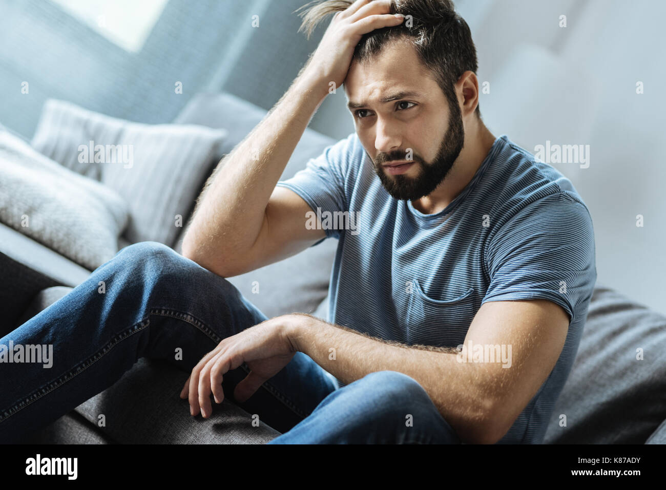 Cheerless moody man being alone Stock Photo - Alamy