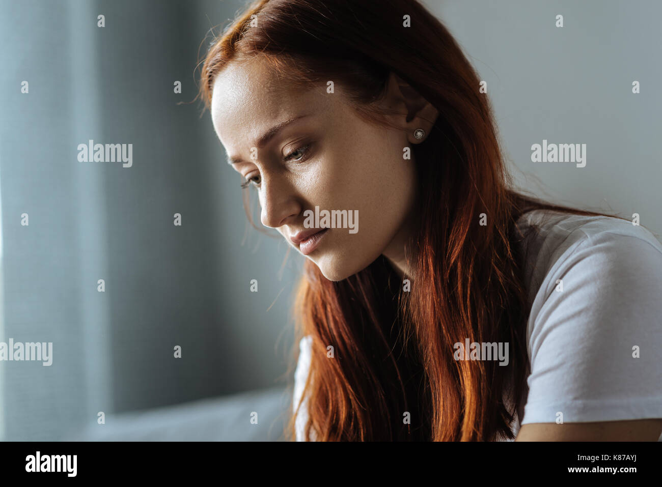 Cheerless beautiful woman feeling melancholic Stock Photo - Alamy
