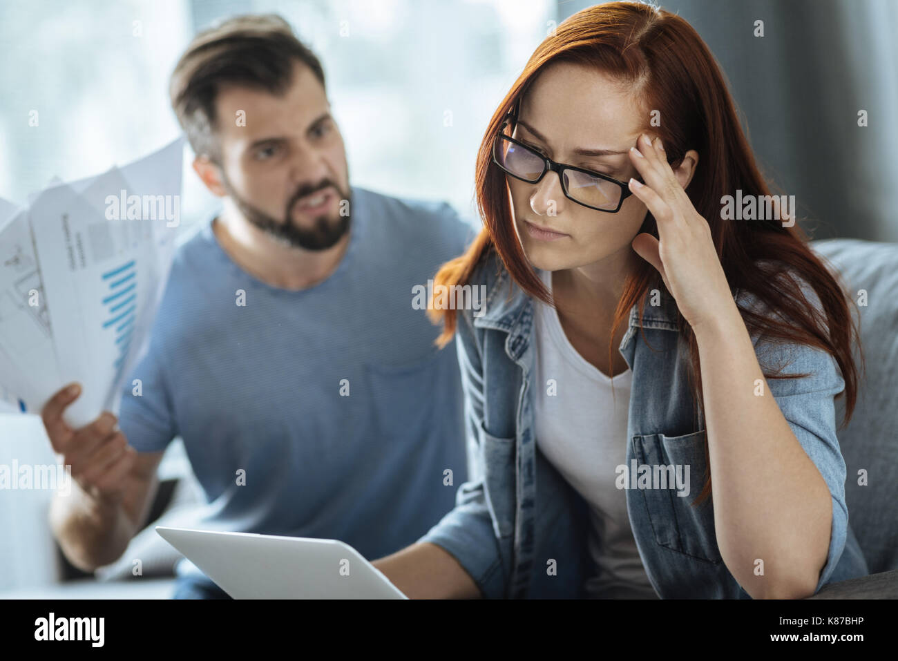 Sad unhappy woman trying to focus on work Stock Photo - Alamy