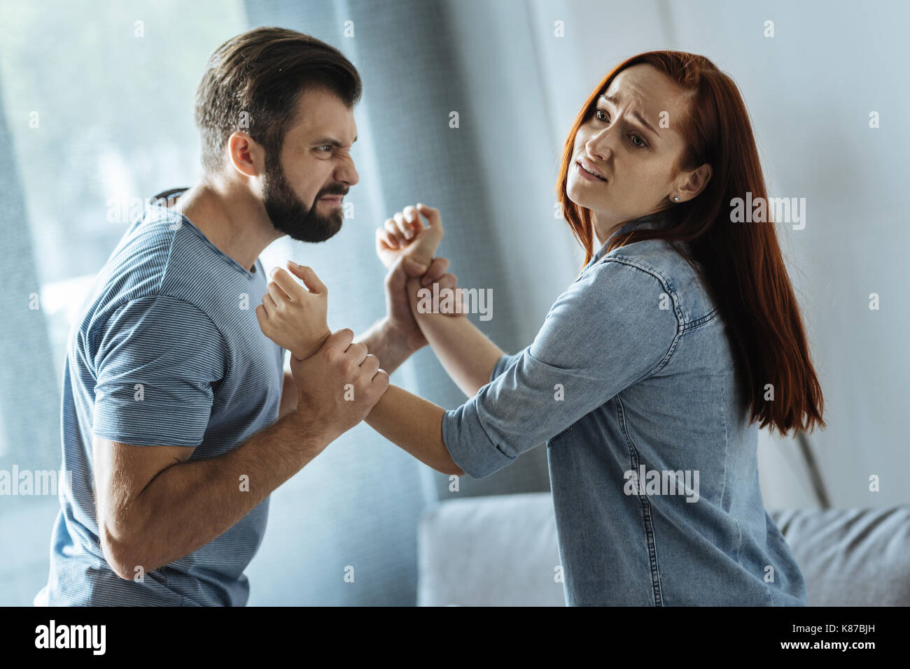 Strong brutal man holding his wife Stock Photo - Alamy