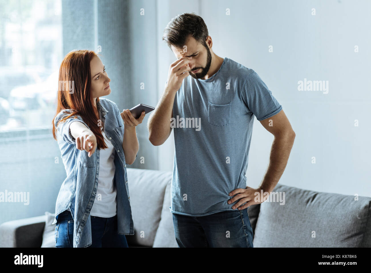 Serious smart woman sending away her boyfriend Stock Photo - Alamy