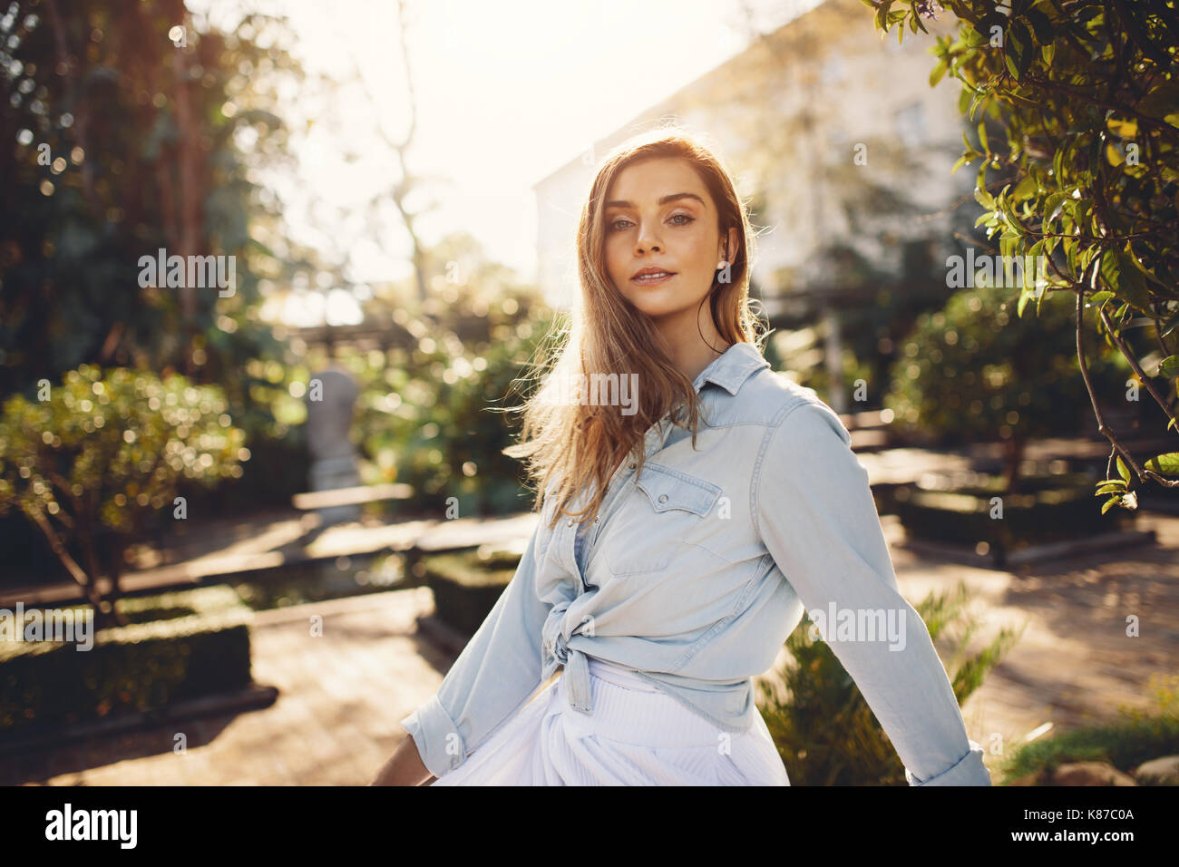 Portrait of beautiful female model looking at camera. Young woman at a ...