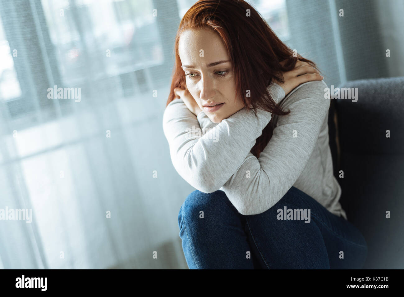 Cheerless sad woman feeling lonely Stock Photo - Alamy