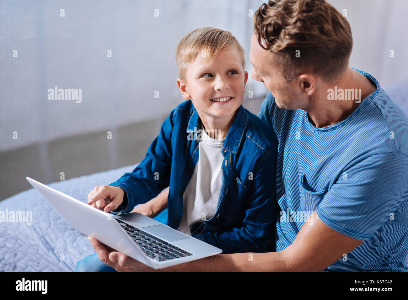Little boy discussing cartoon with his father Stock Photo - Alamy