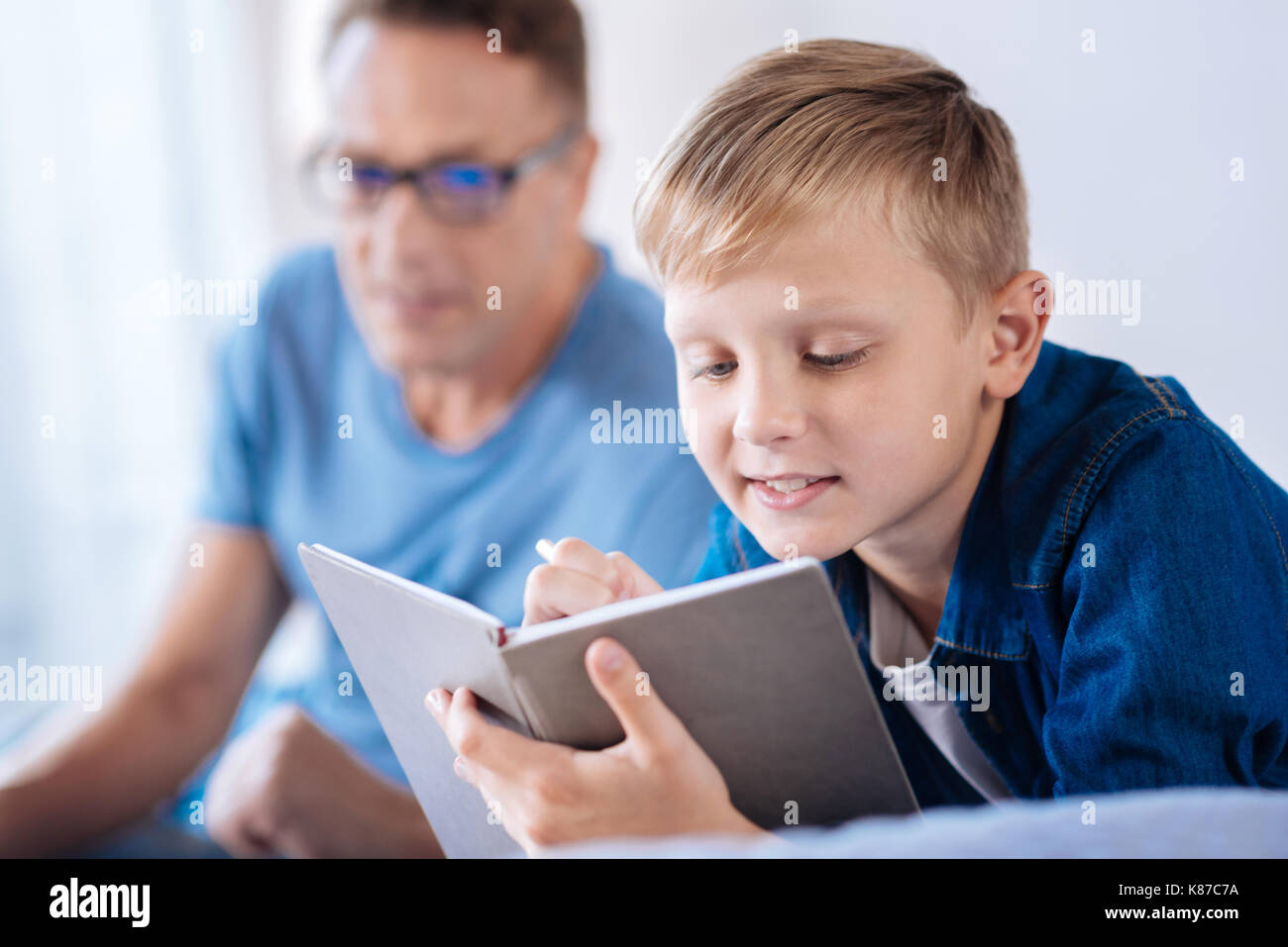 Cute pre-teen boy writing poems in his diary Stock Photo - Alamy
