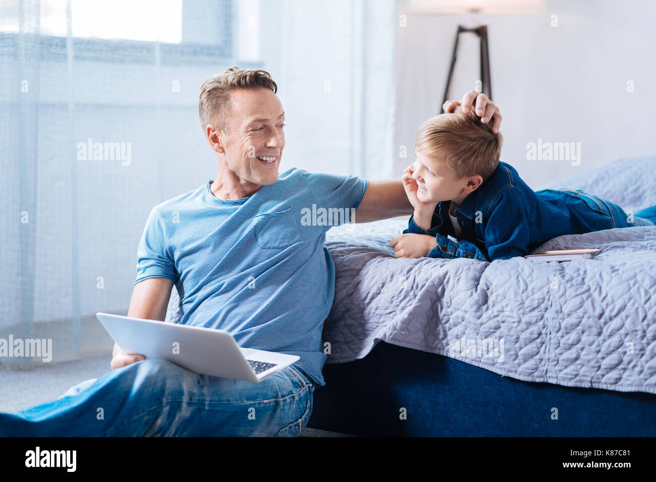 Happy young father ruffling his sons hair Stock Photo - Alamy