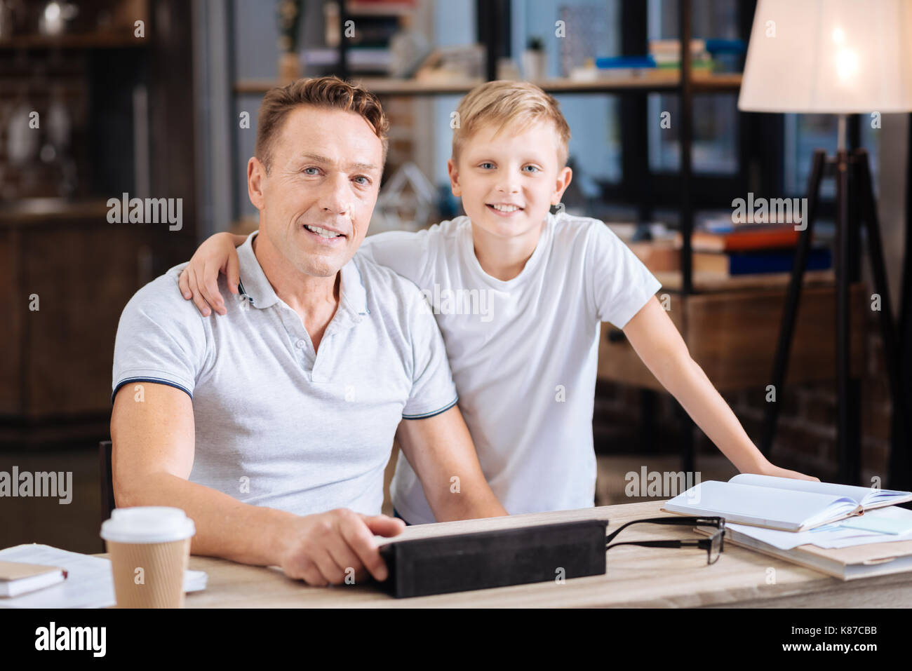 Happy father and son posing in fathers study Stock Photo - Alamy