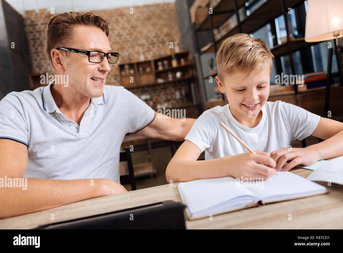 Pre-teen boy doing homework with father in the study Stock Photo - Alamy