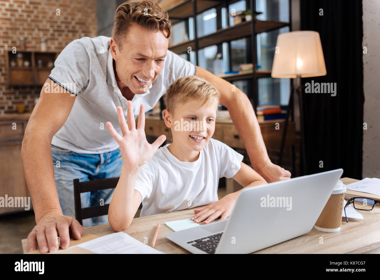 Upbeat father and son making a video call together Stock Photo - Alamy