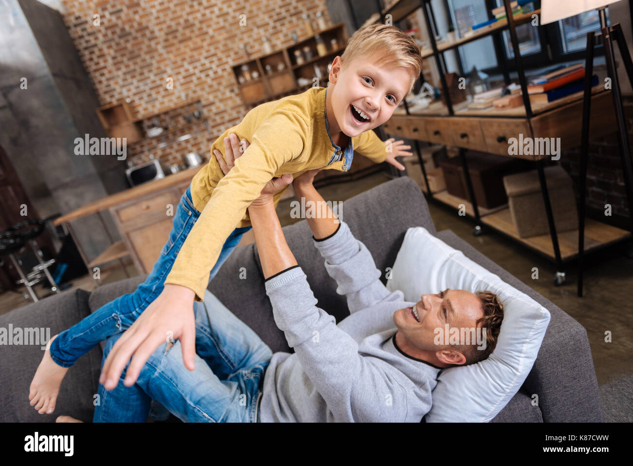 Happy boy being lifted up by his father Stock Photo - Alamy
