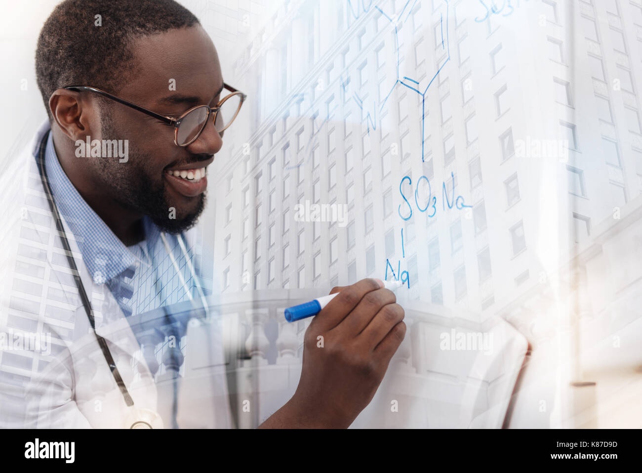 African American doctor writing down chemical composition Stock Photo ...