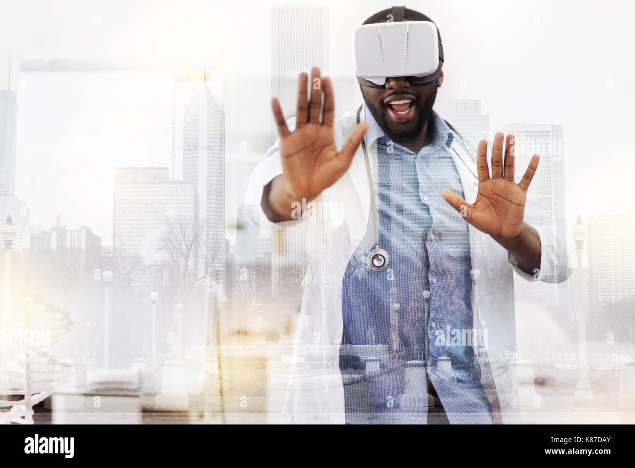 Cheerful doctor using virtual reality mask Stock Photo - Alamy