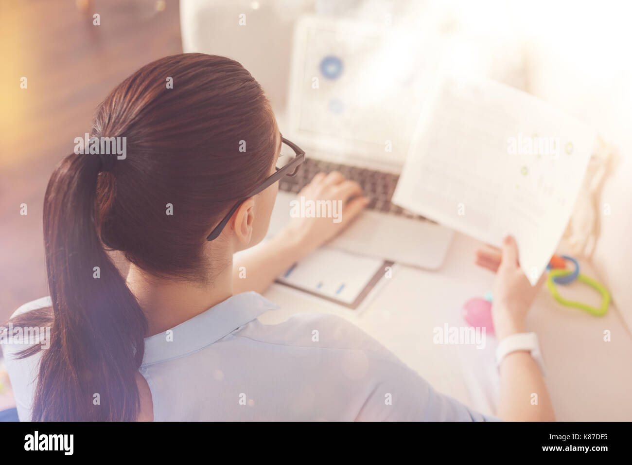 Back view of serious office worker while doing task Stock Photo - Alamy