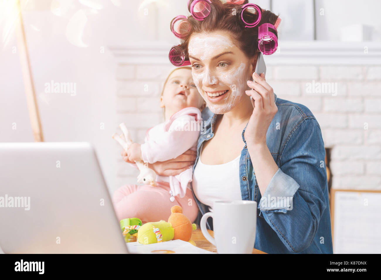 Positive delighted female holding her baby Stock Photo - Alamy