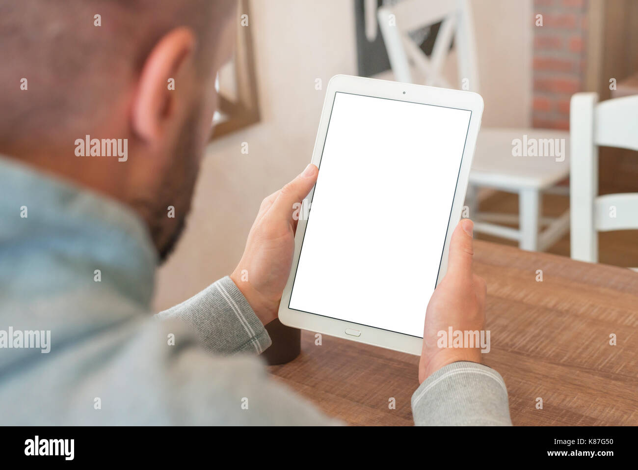Closeup tablet in man hands. Vertical position. Isolated screen for ...