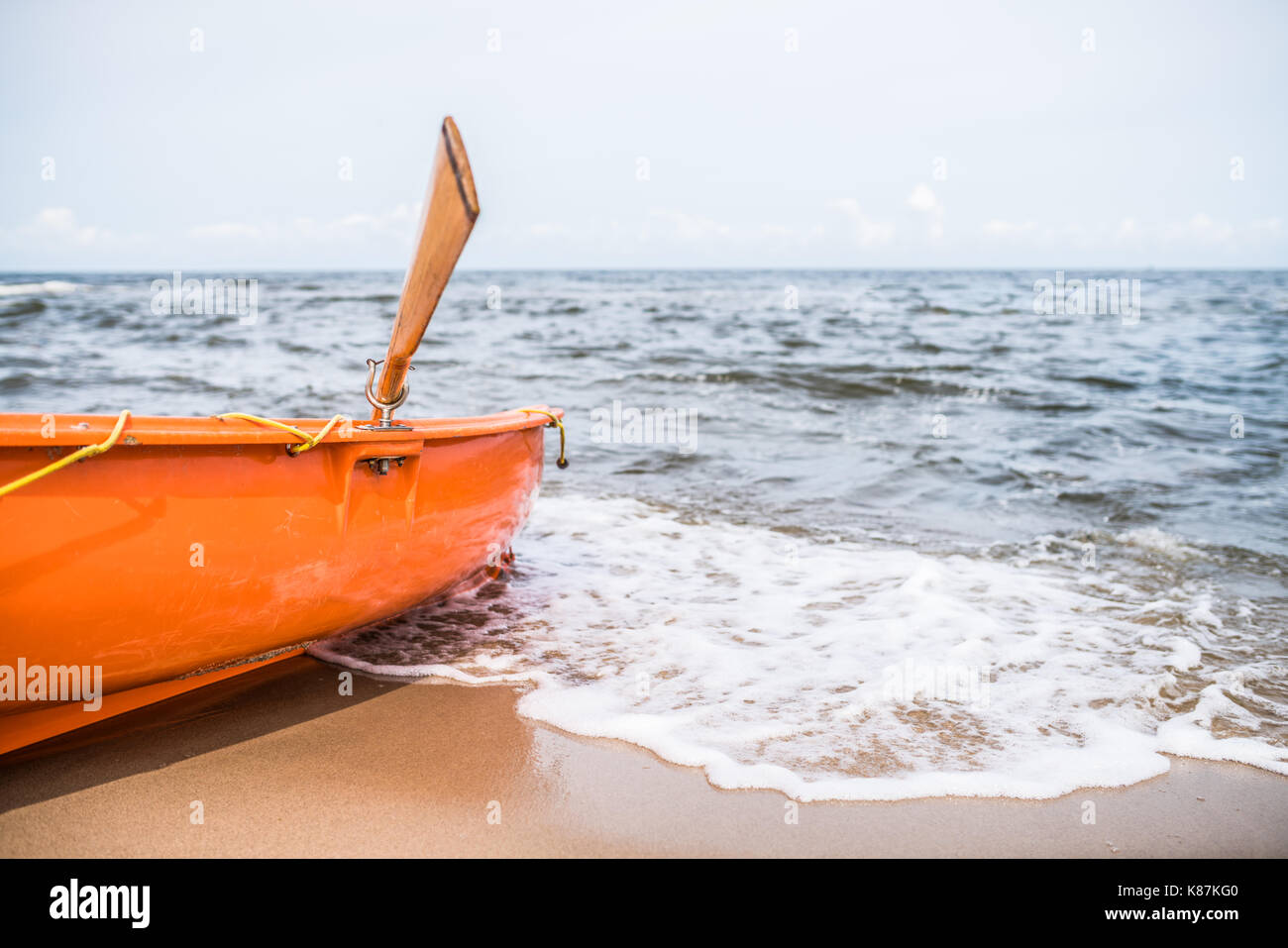 Orange lifeguard rescue boat on the beach in summer Stock Photo - Alamy