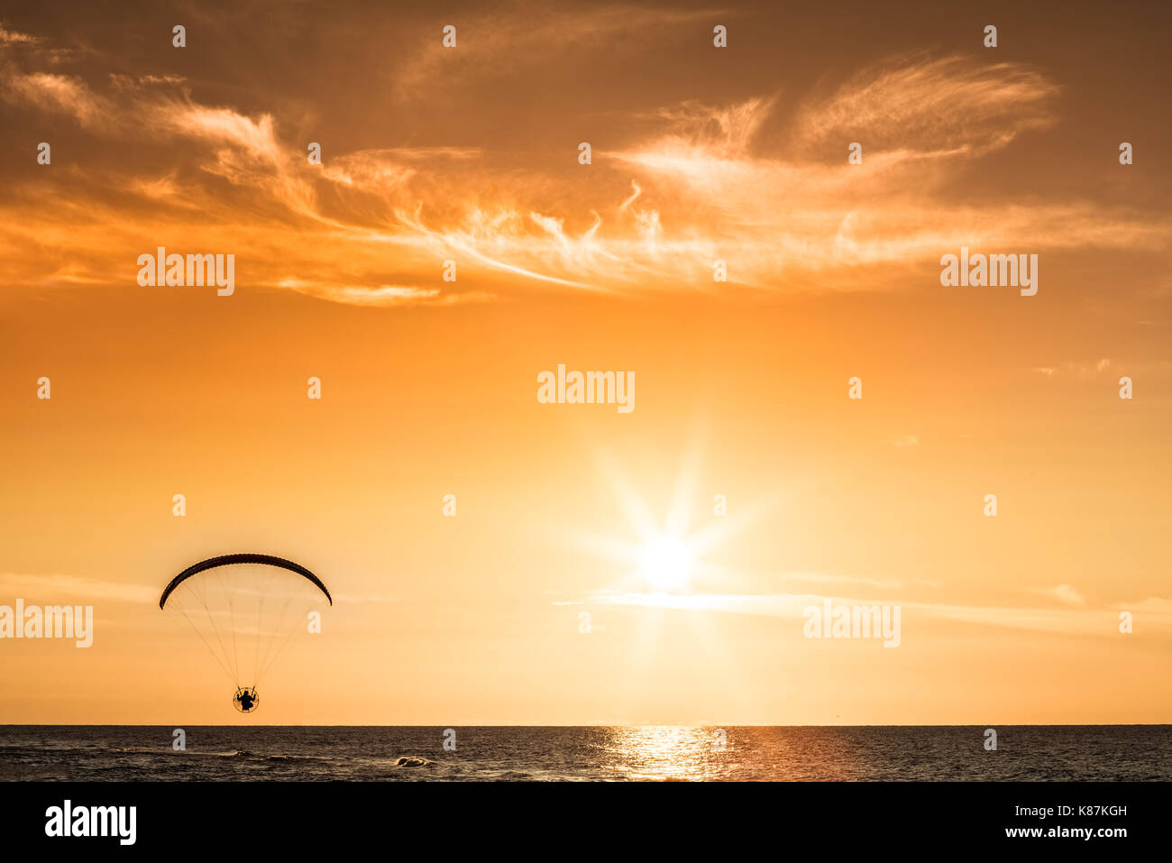 Paraglider flying with a paramotor during beautiful sunset Stock Photo ...