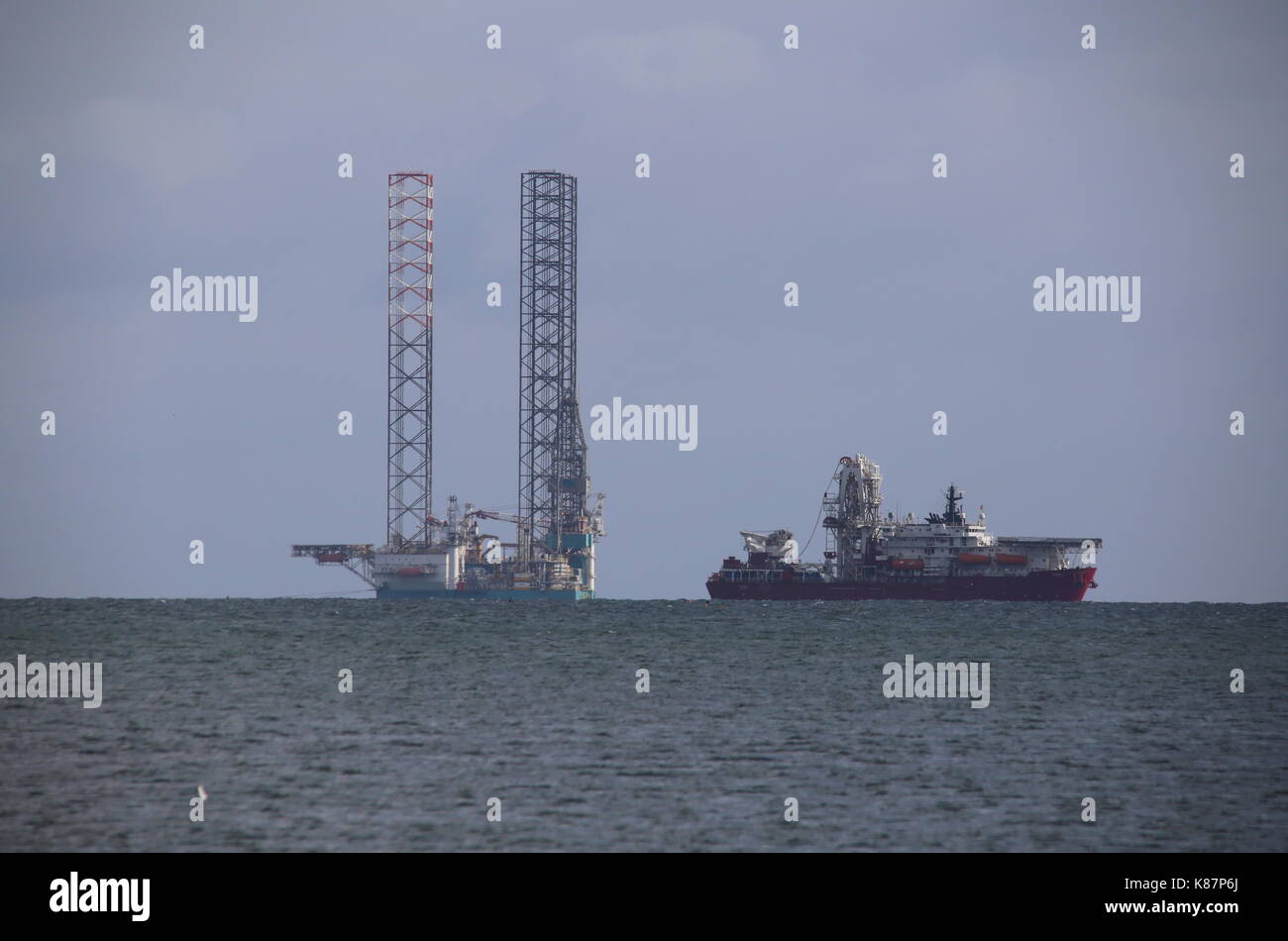 Oil Rig Rowan Stravanger under tow passing vessel viewed from coast of ...