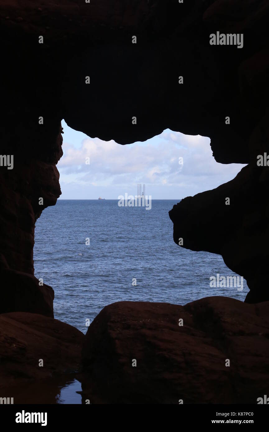 Oil Rig Rowan Stravanger under tow viewed through Needles Eye rock arch ...