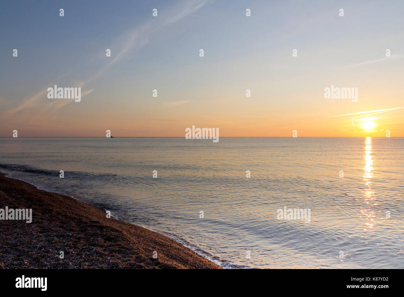 Dawn sun rising over a calm colorful Mediterranean sea Stock Photo - Alamy